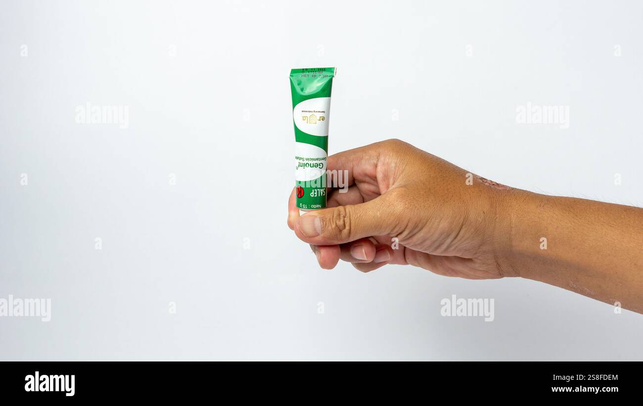 Hand holding genoint. Genoint is an eye drop, eye ointment and skin ...