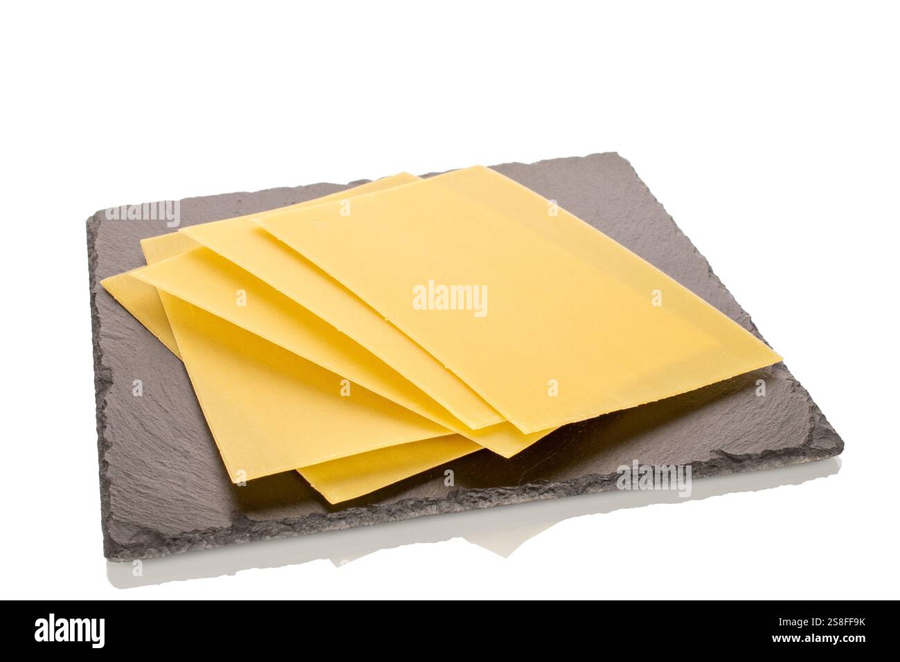 Durum wheat pasta, lasagna on slate stone, close-up, isolated on white ...