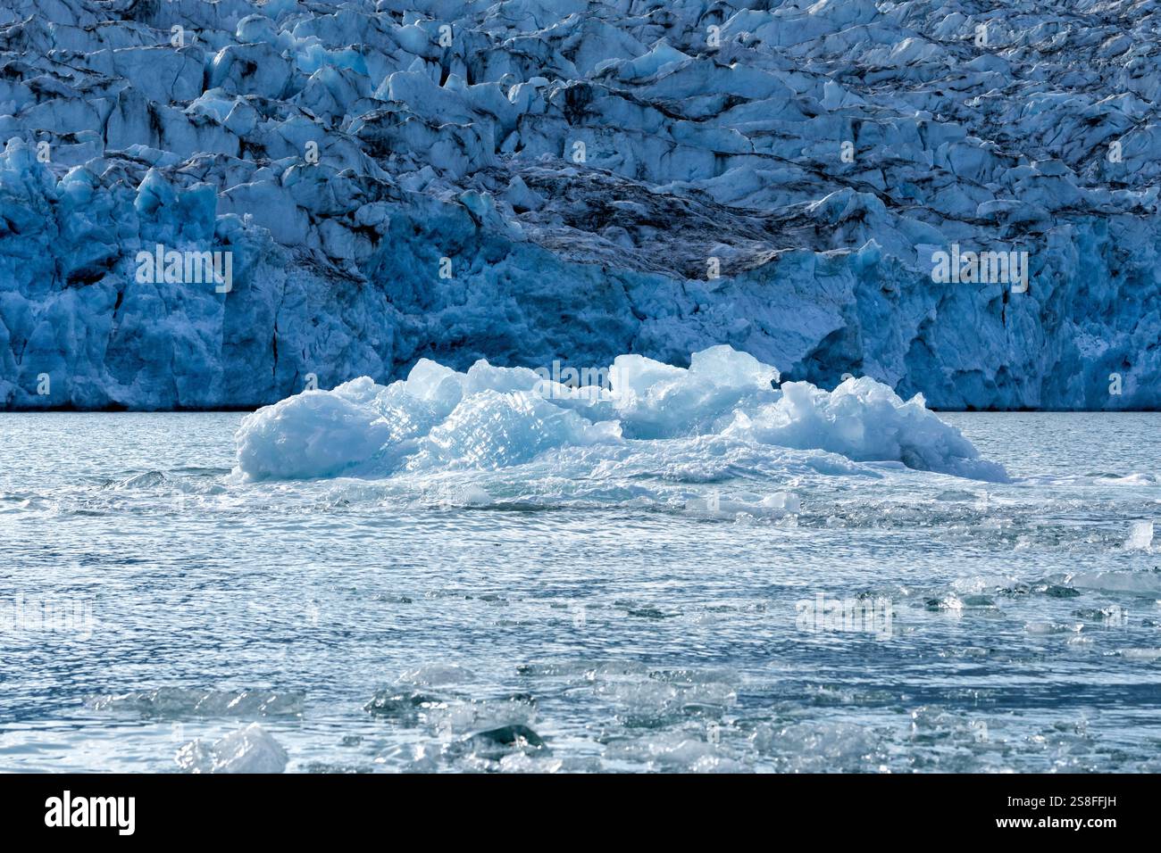 Glacial fragments of ice floating in seawater very close to a glacier ...