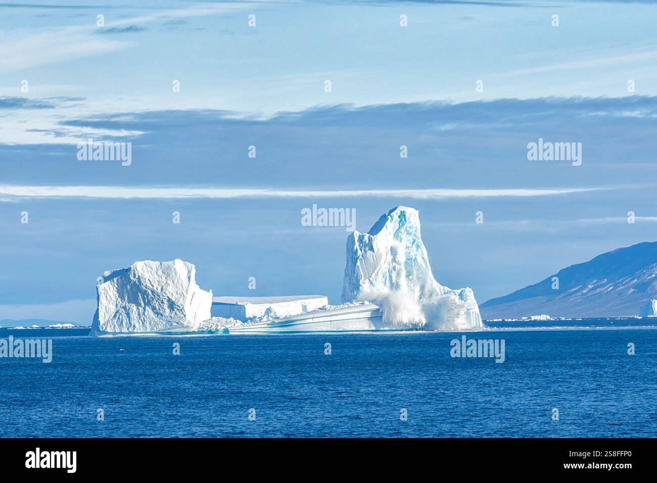 The arch of an iceberg collapses. This photo is one of several that ...