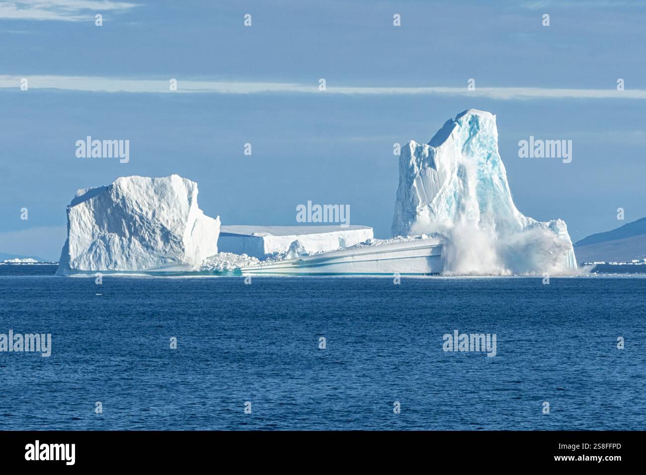 The arch of an iceberg collapses. This photo is one of several that ...