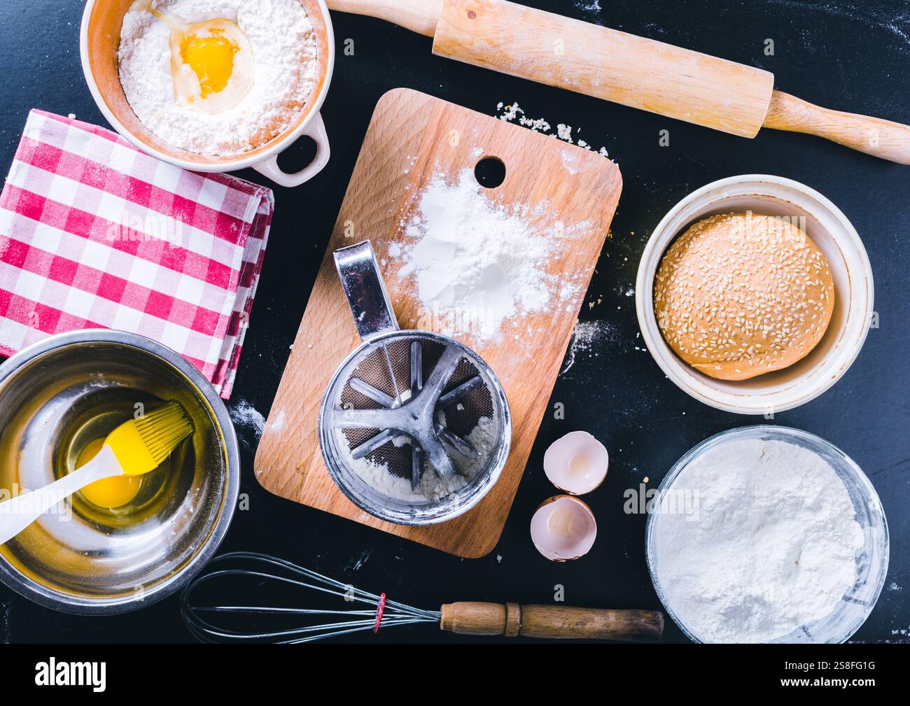 Baking dark background with blank cook book, eggshell, bread, flour ...