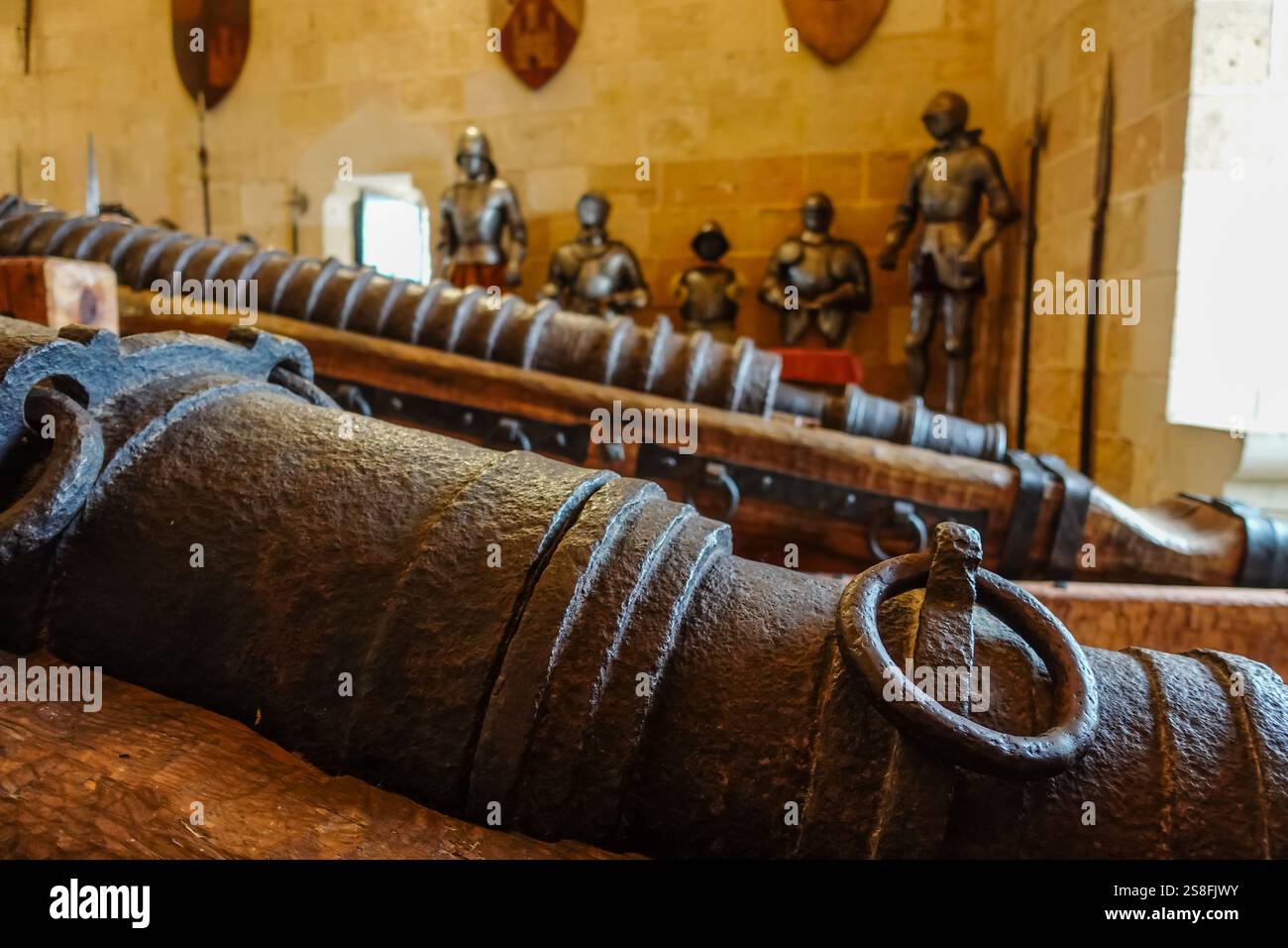 Armory room inside Alcázar de Segovia, Spain. Display of medieval weapons and armor, including ...