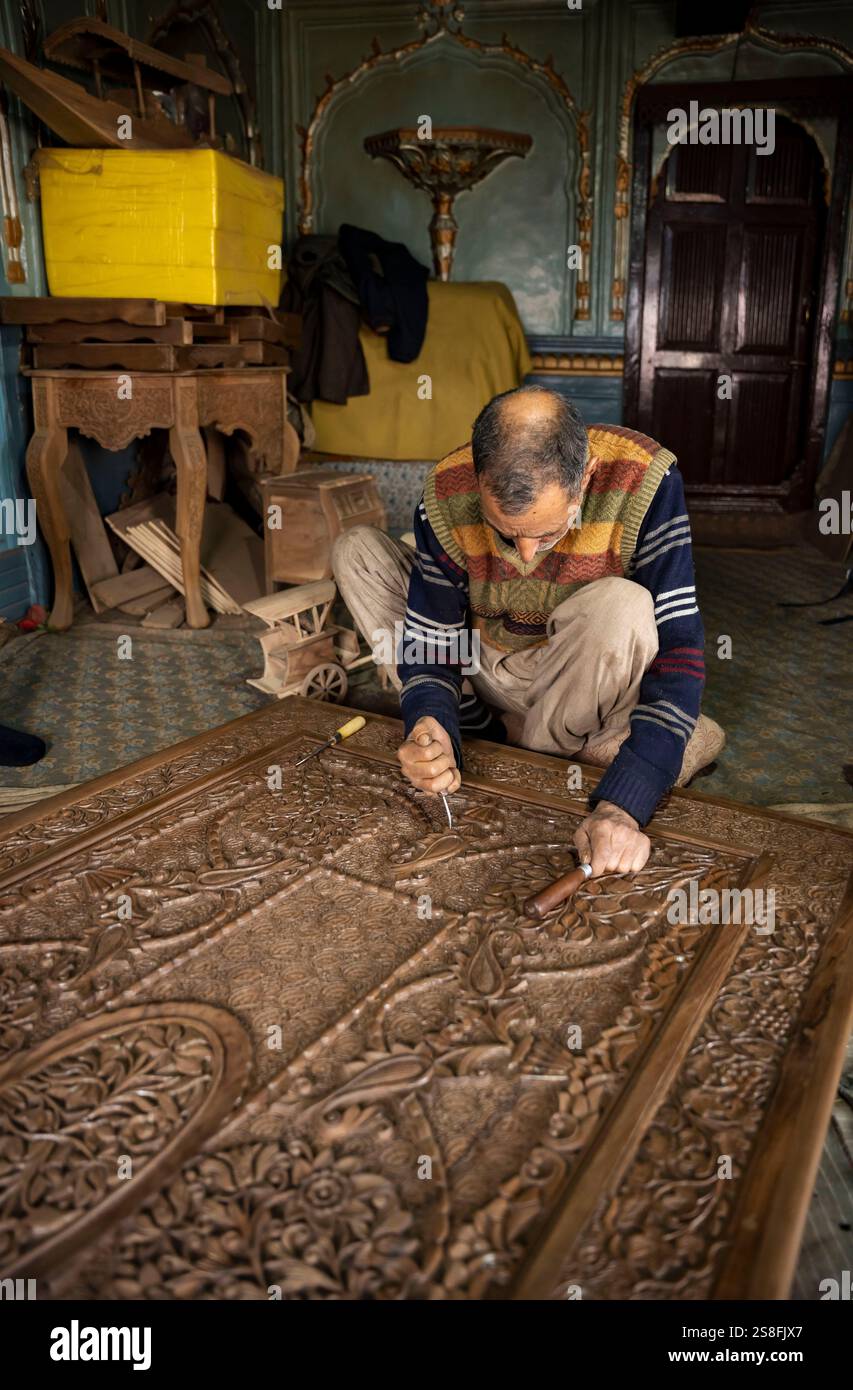 A craftsman is seen using a tool to brighten and polish a wood-crafted ...