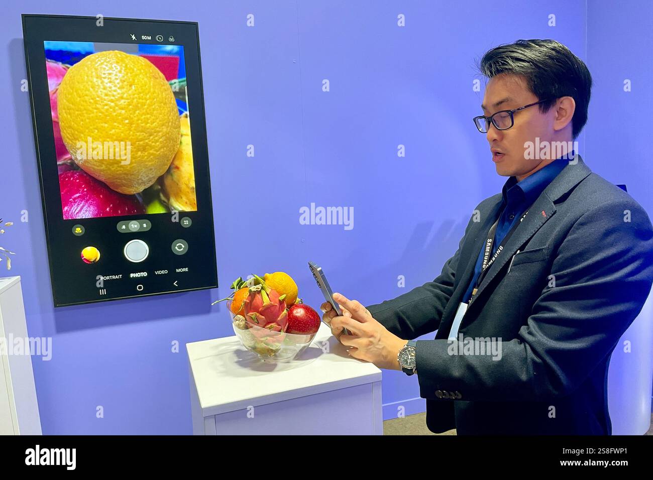 A Samsung employee shows off the new Samsung Galaxy S25 phone, with ...