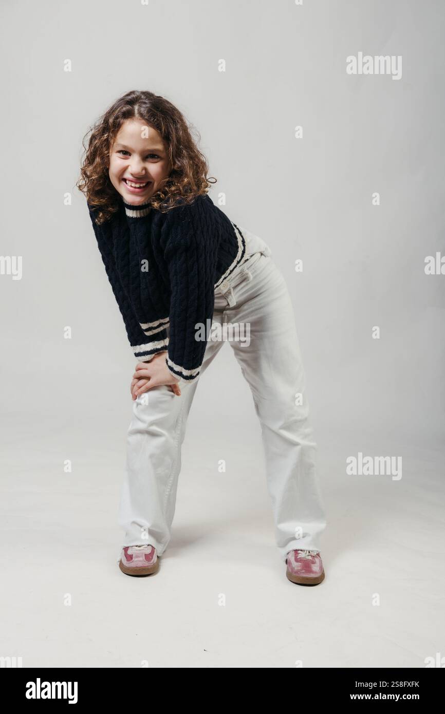 Happy 9-year-old girl posing in studio with joyful expression Stock ...