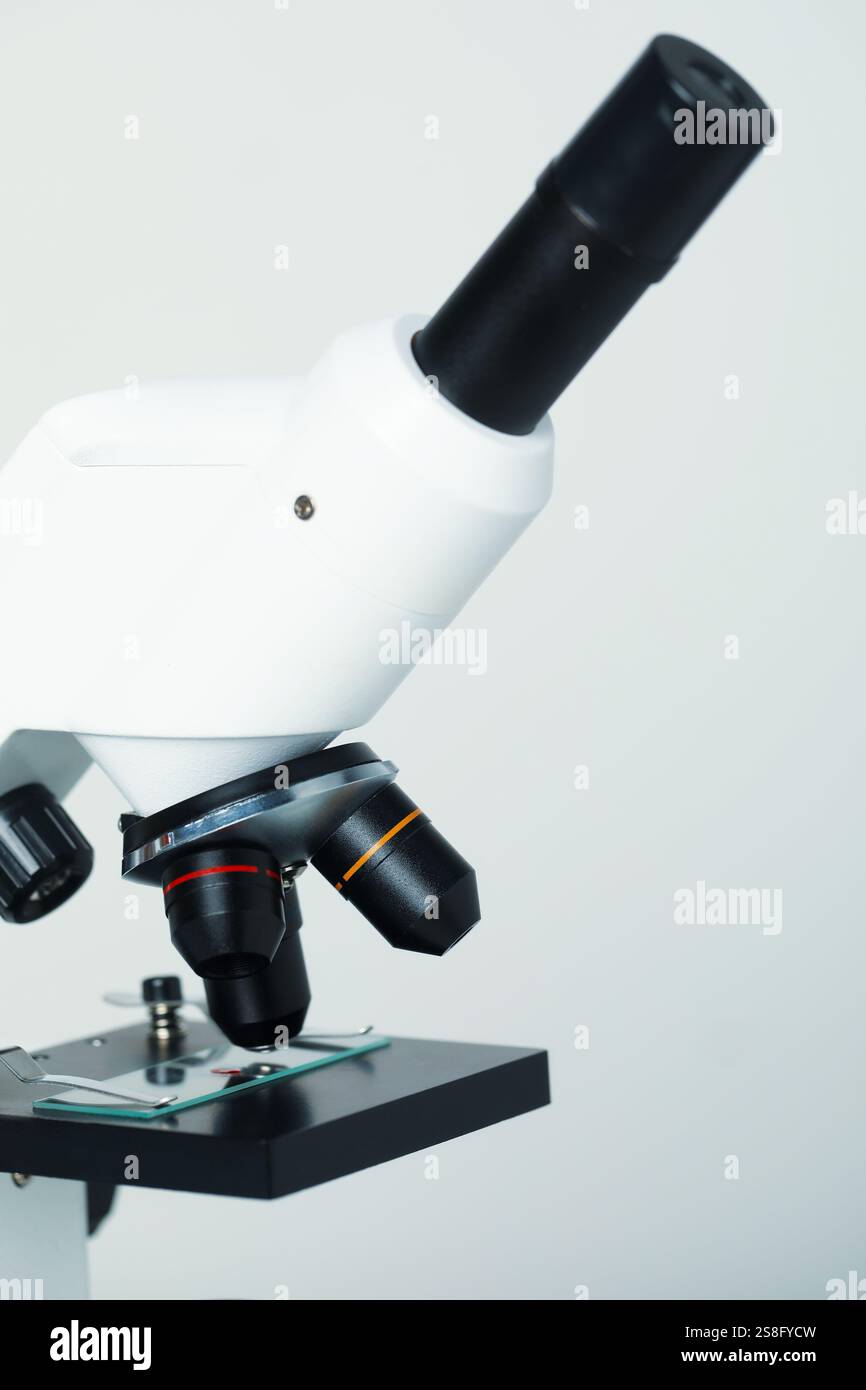 Science. Microscope with glass slide on light grey background, closeup ...