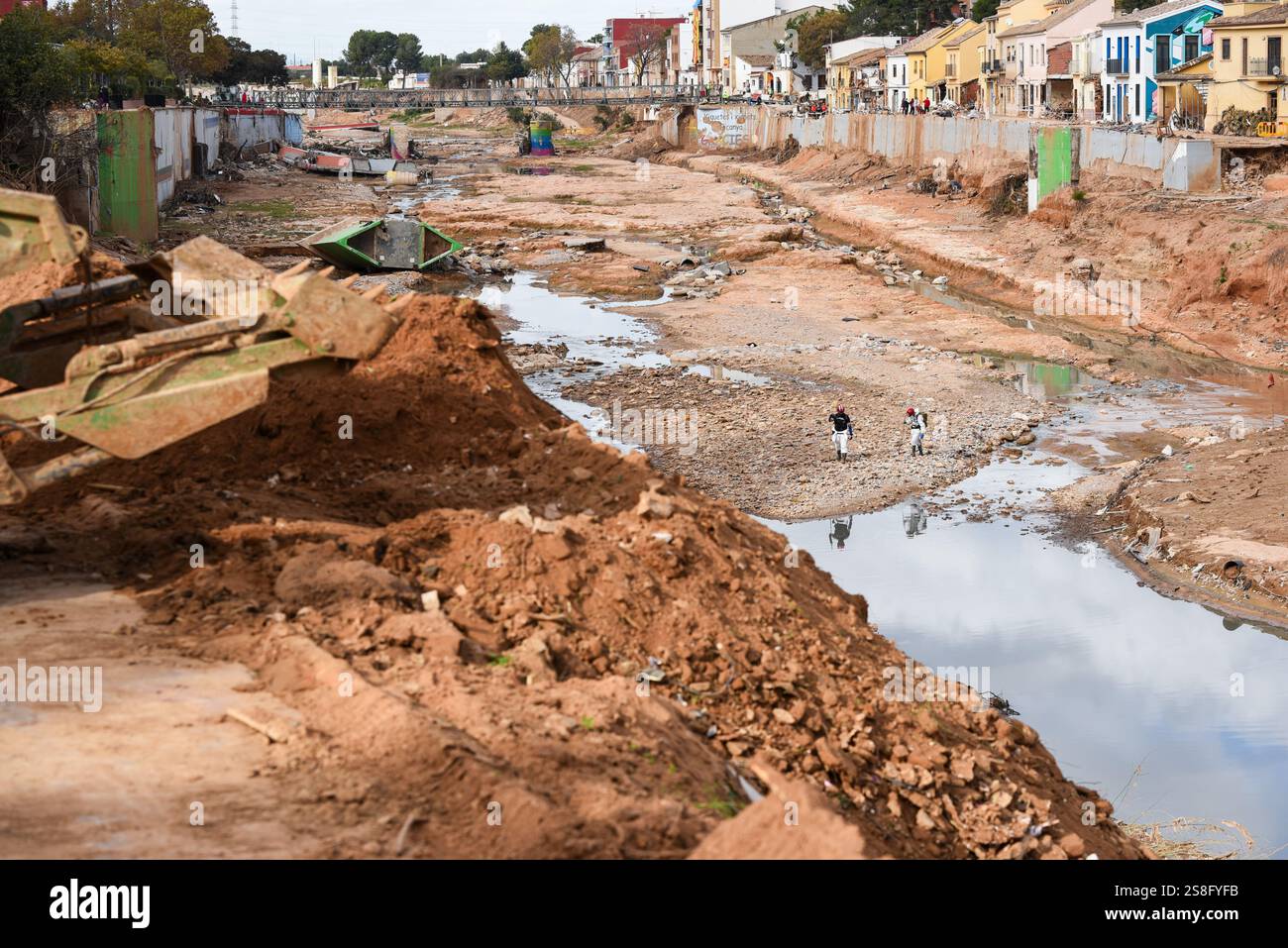Volunteers on the riverbed of Poyo ravine in reconnaissance and rubble ...