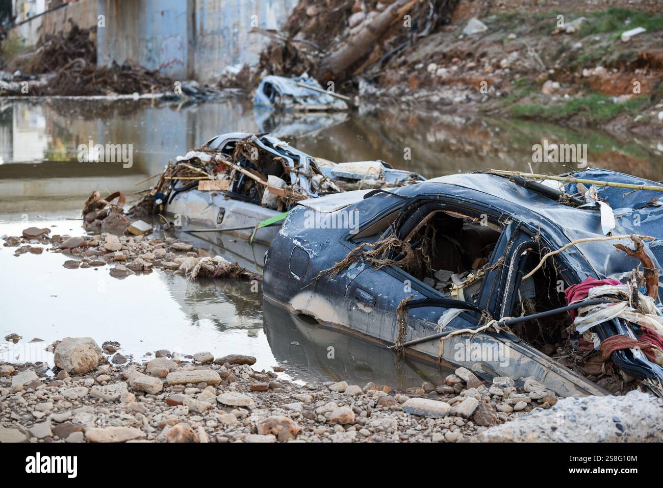 Cars buried and flooded on the riverbed of Rambla del Poyo (Poyo ravine ...