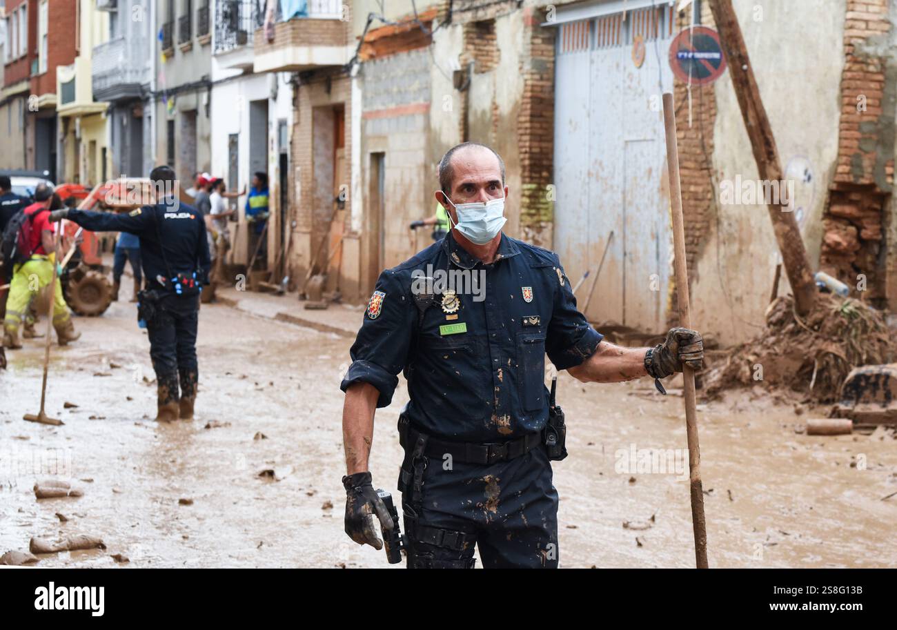 Policeman wearing mask during cleanup operations after natural disaster ...