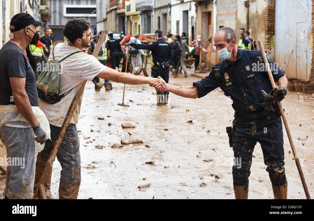 Cooperation between police and people. Policeman shaking hands with a ...