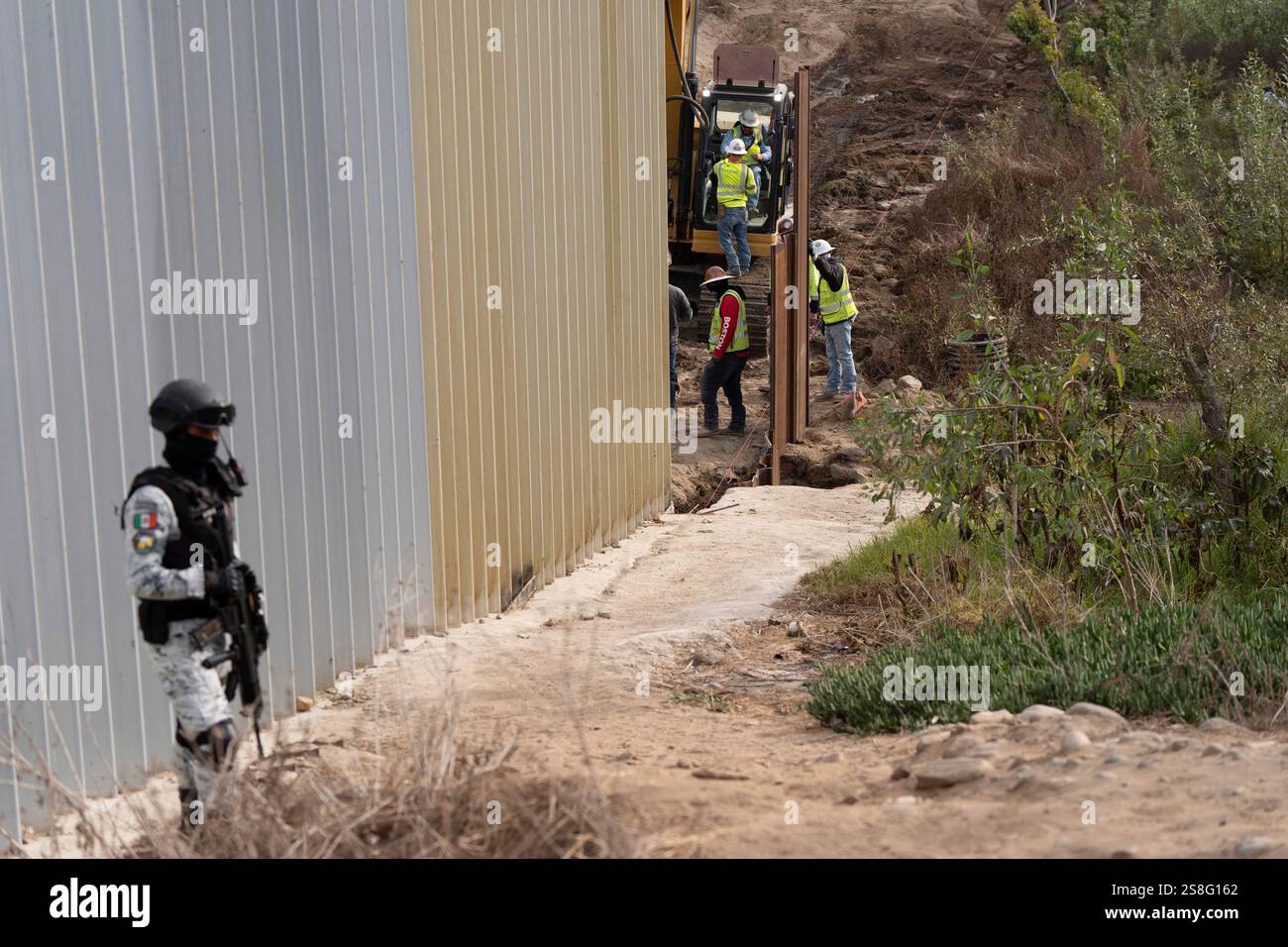 A member of the Mexican National Guard stands guard, left, as ...