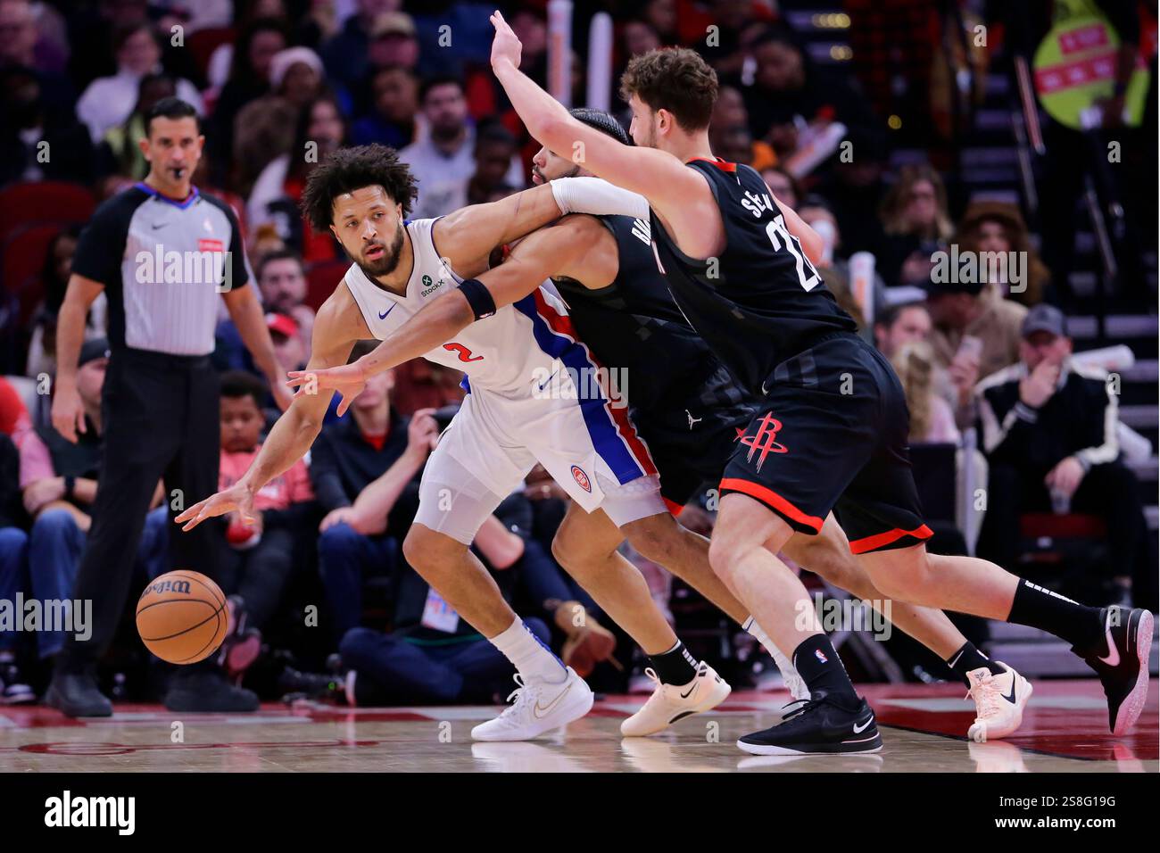 Detroit Pistons guard Cade Cunningham, left, tries to protect the ball ...