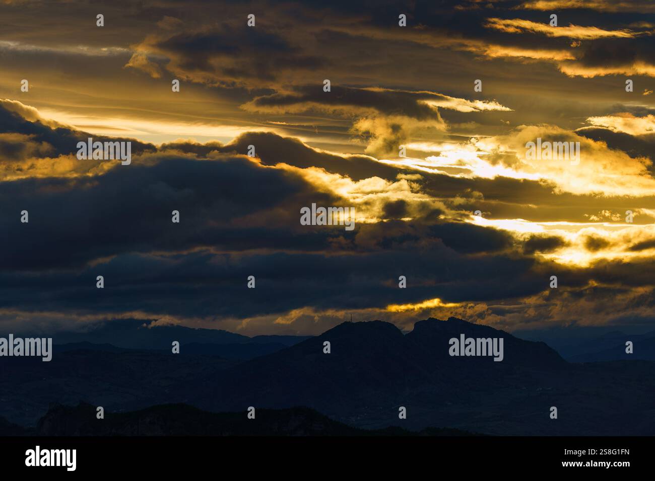 Majestic sunset over mountain range with dramatic clouds and vibrant ...