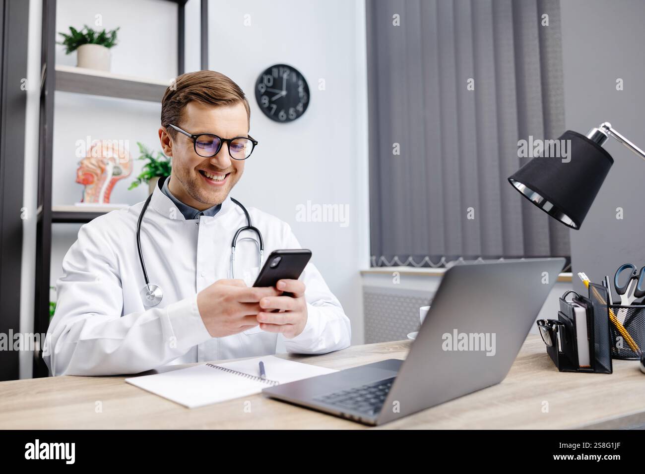 Male doctor medical worker in modern clinic wearing eyeglasses and ...