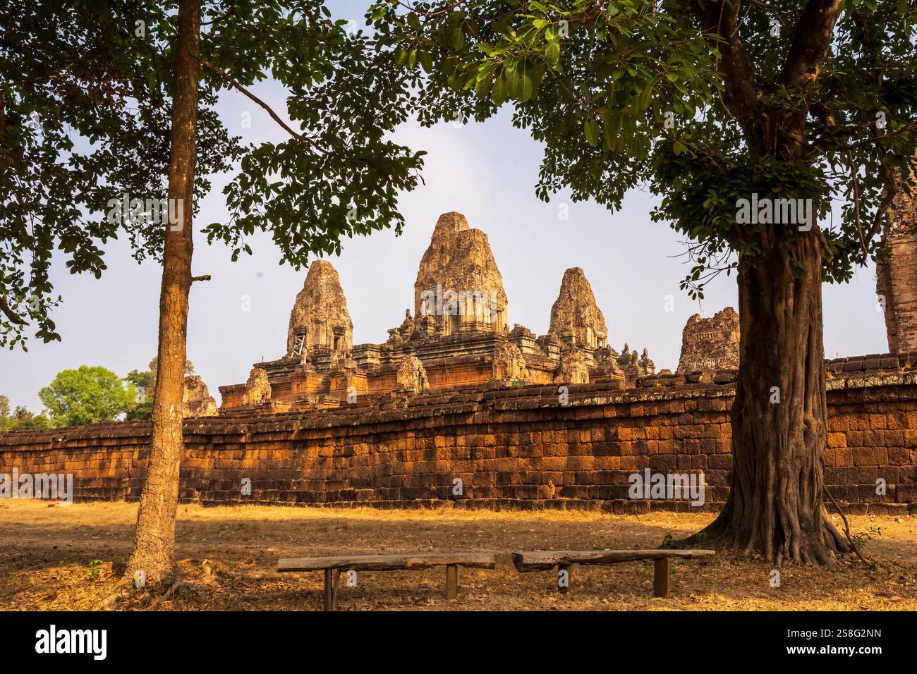Pre Rup temple emerges beautifully between lush trees under a clear ...