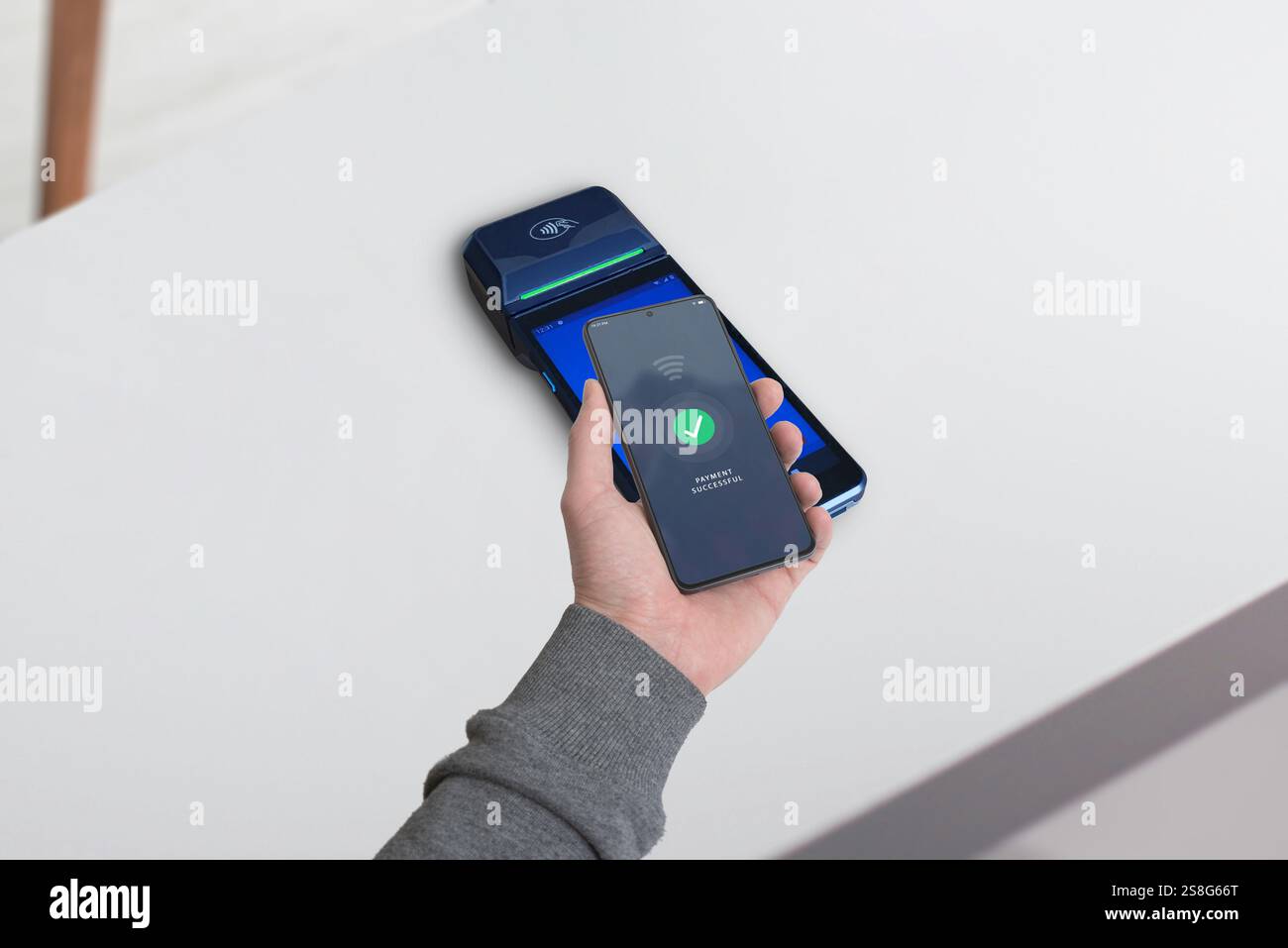 Smartphone completing a payment on a POS terminal with a wireless ...