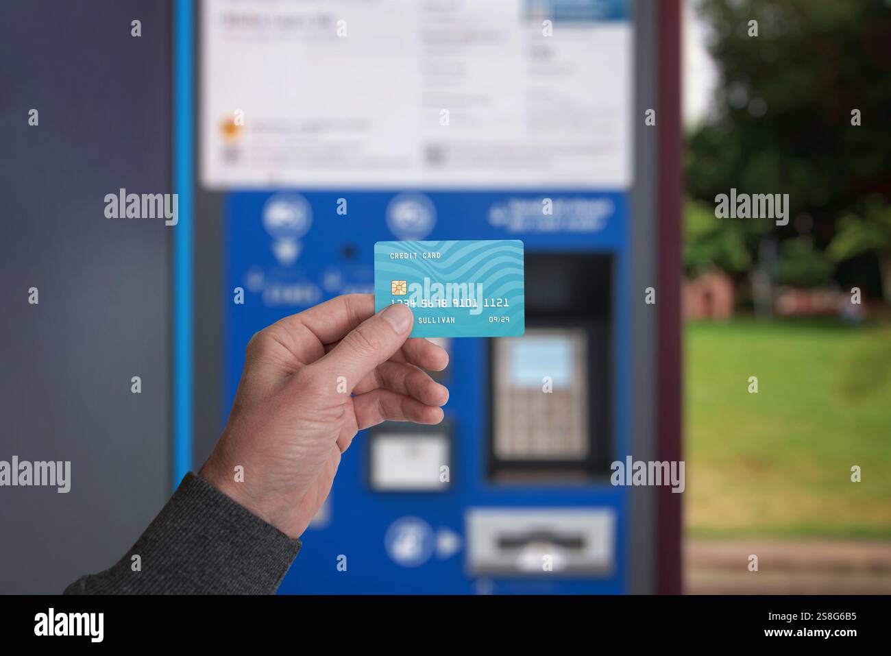 Credit card being used on a street vending machine for purchasing bus ...
