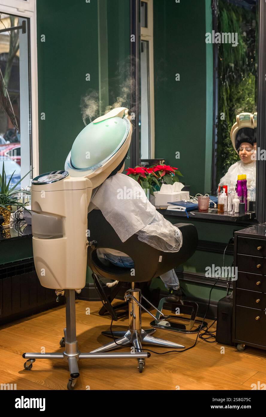 a device in a beauty salon that curls hair Stock Photo - Alamy