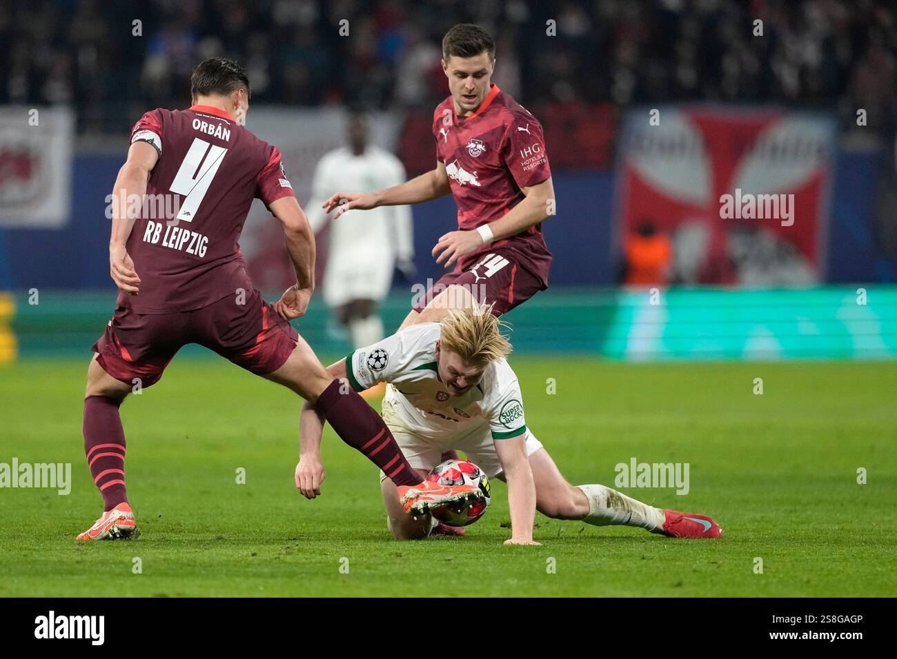 Sporting's Conrad Harder, bottom, challenges for the ball with Leipzig ...