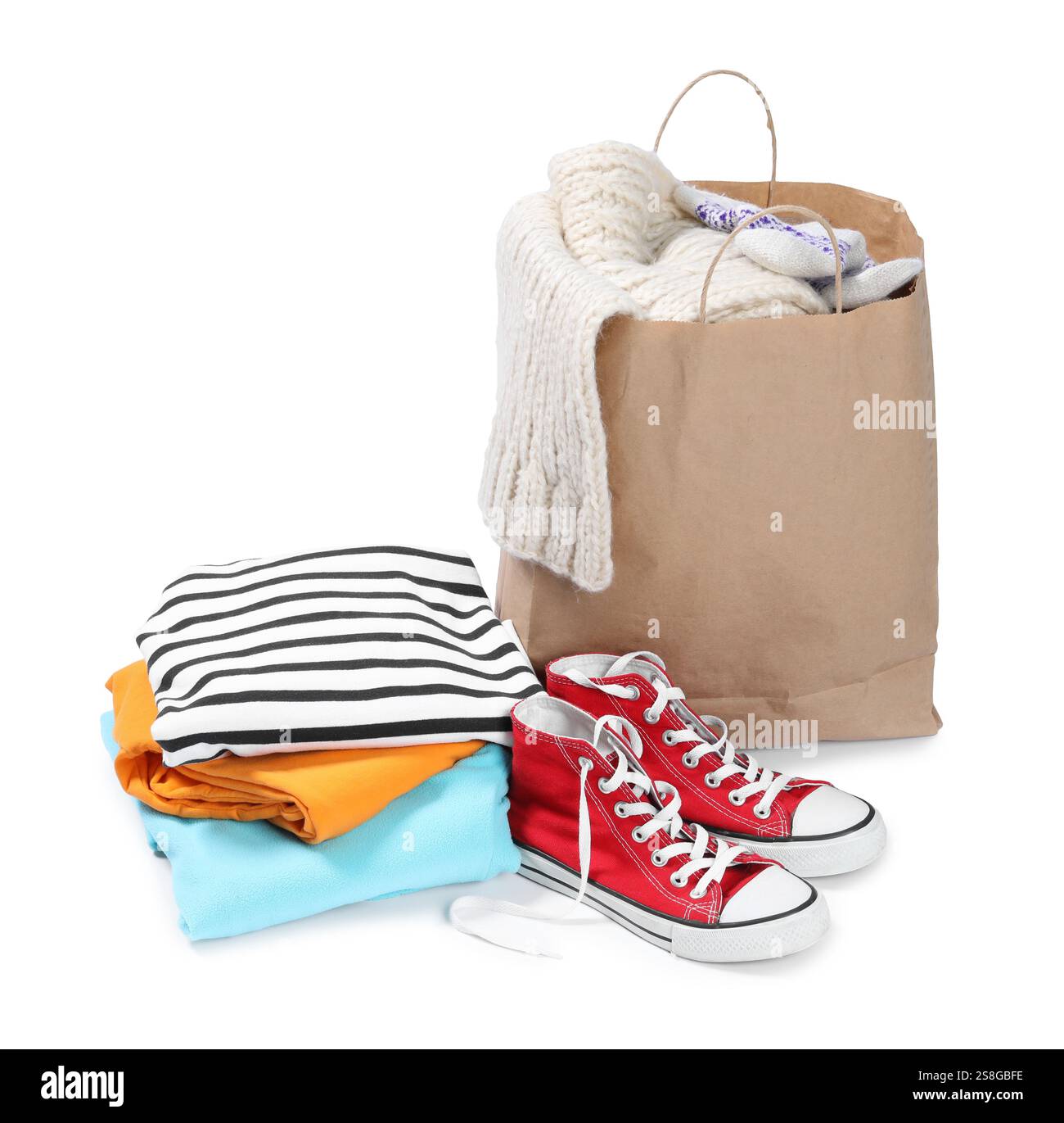 Bag with used clothes and sneakers isolated on white Stock Photo - Alamy