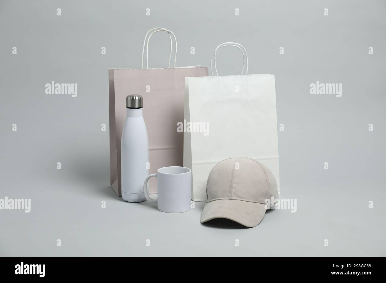 Different blank items for branding on light grey background. Mockup for ...