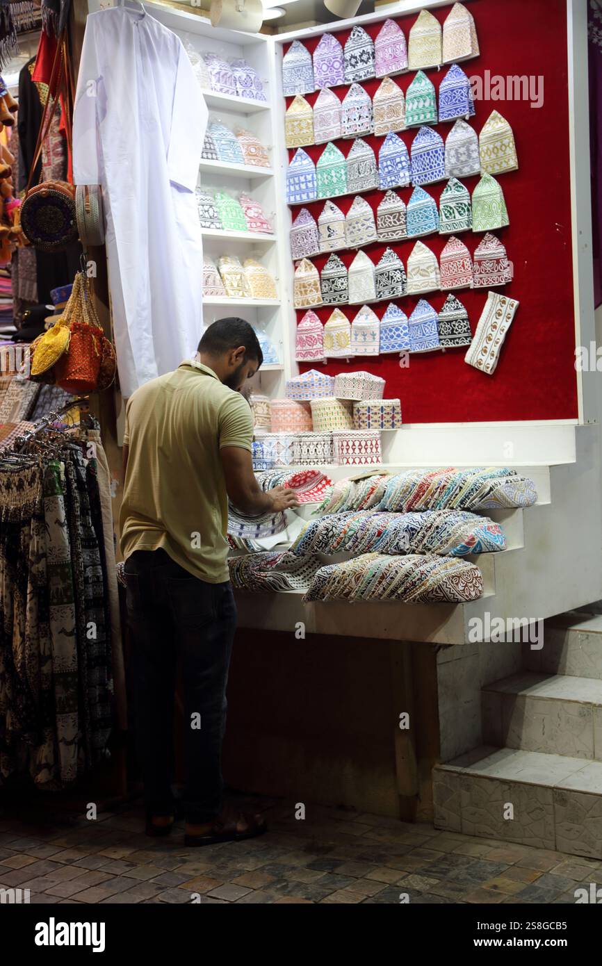 Man looking at Kumas Traditional Omani Caps Mutrah Souk Muscat Oman ...
