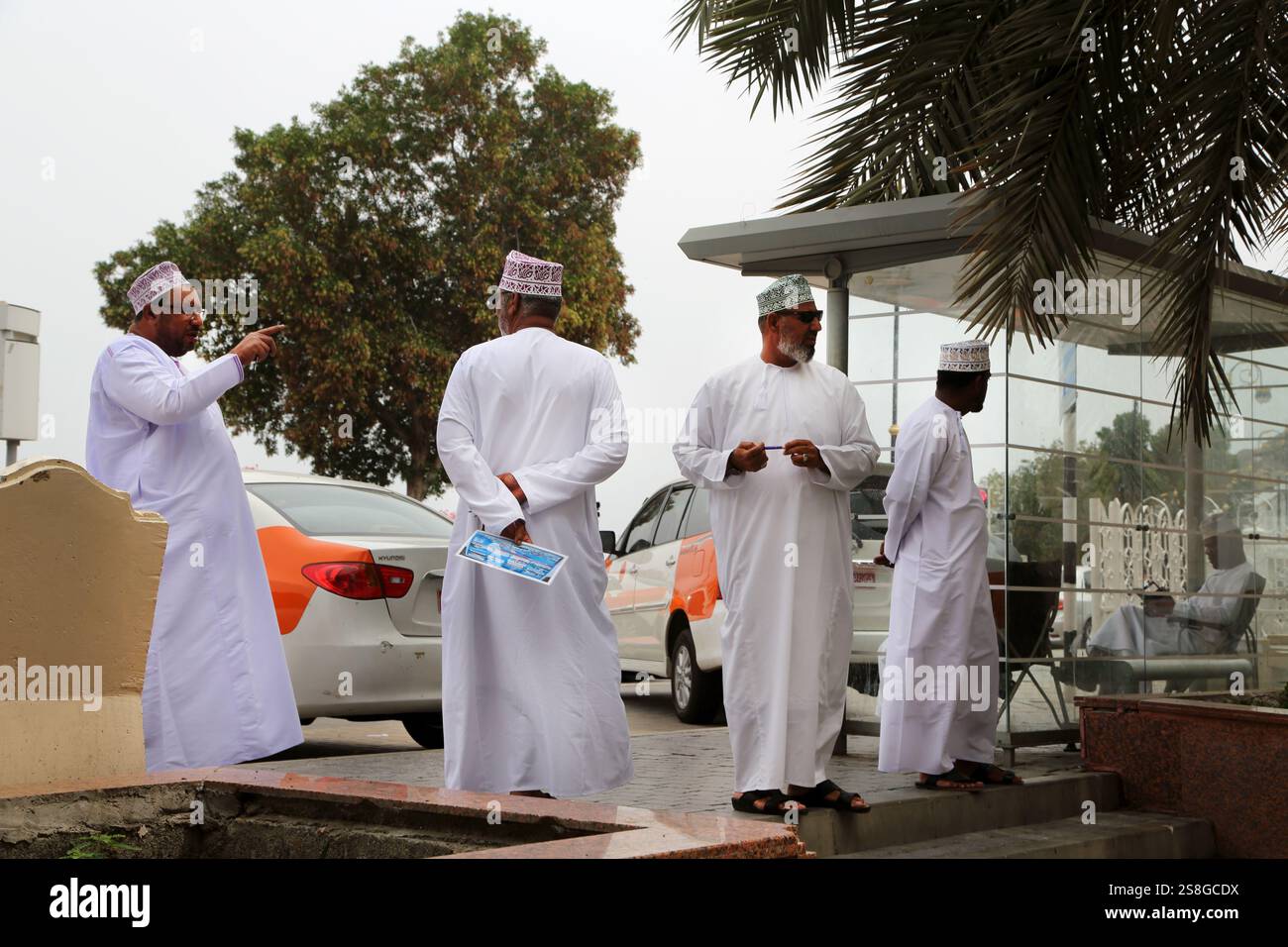 A group of Taxi Drivers at Taxi Rank wearing Traditional Omani Clothing ...