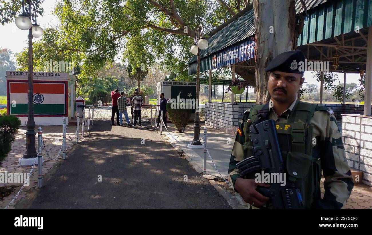 An Indian Border Security Force (BSF) soldier stands guard as visitors ...