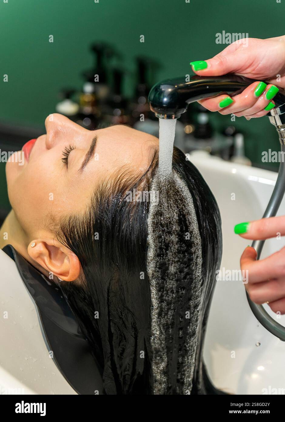 In a beauty salon, a client girl's hair is washed Stock Photo - Alamy