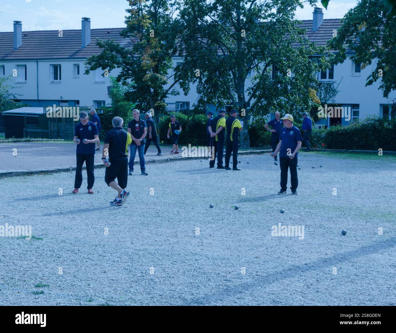 A group of men play lawn bowling (the boules) in Le Mele-sur-Sarthe ...