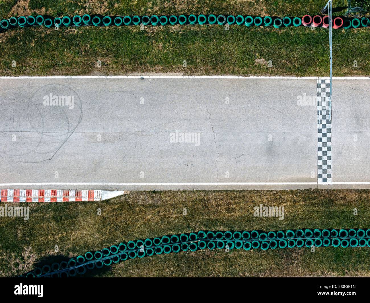 An aerial view captures a motorcar racing track featuring several sharp ...