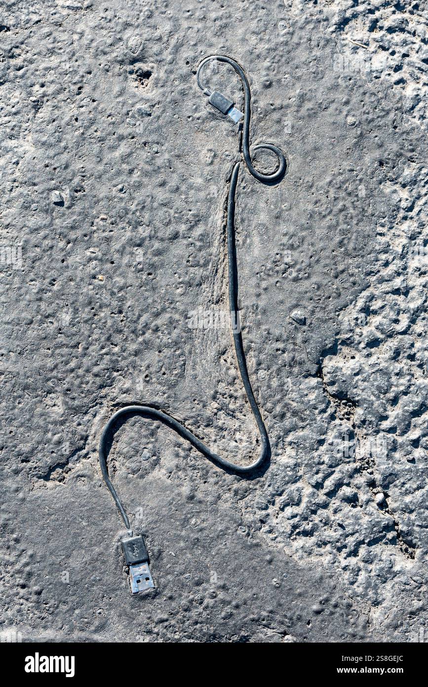 USB cable encased in concrete in a parking lot in Stanfield, Oregon ...