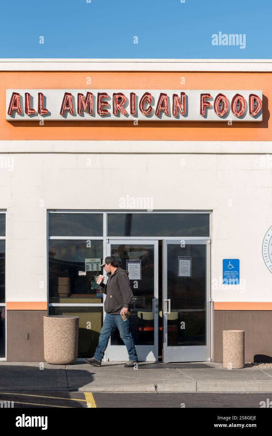 Drinking from a paper cup outside an A&W restaurant in Stanfield ...