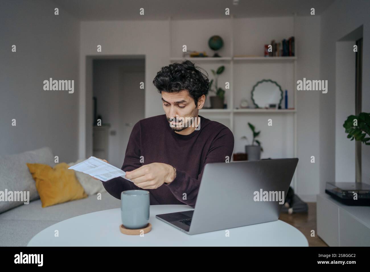 Young stressed looking handsome middle eastern man using computer and ...