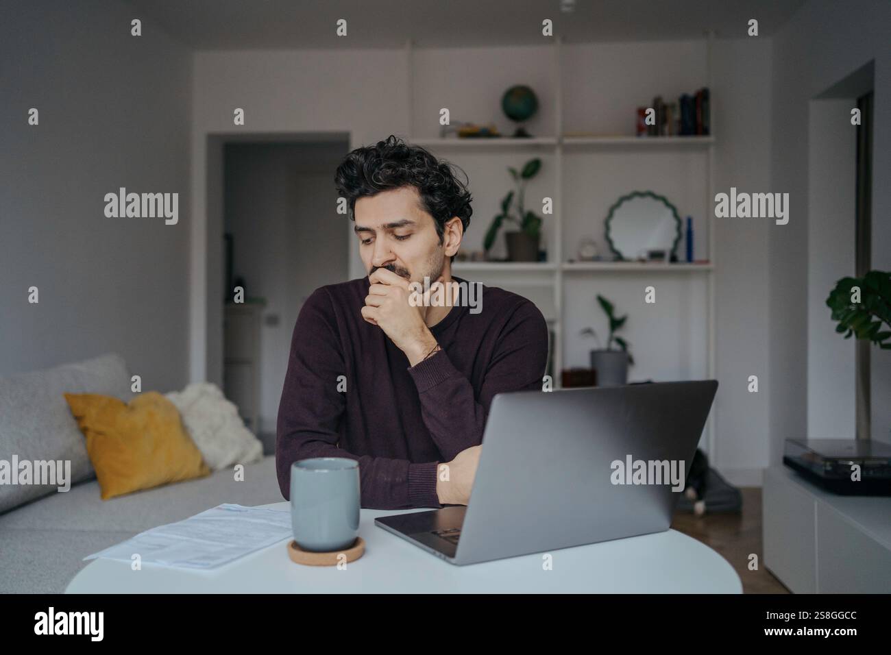 Young stressed looking handsome middle eastern man using computer and ...