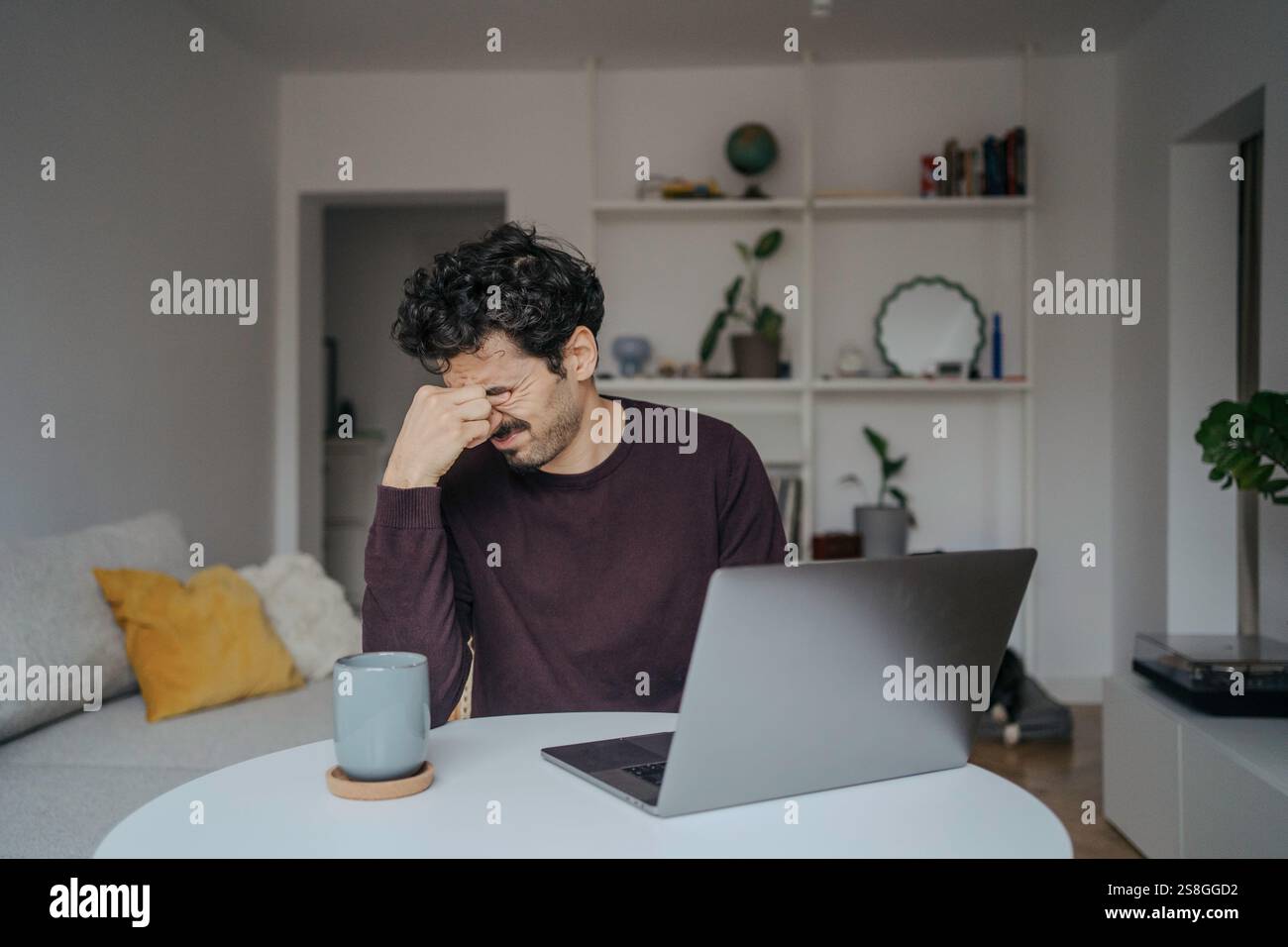 Young stressed looking handsome middle eastern man using computer and ...
