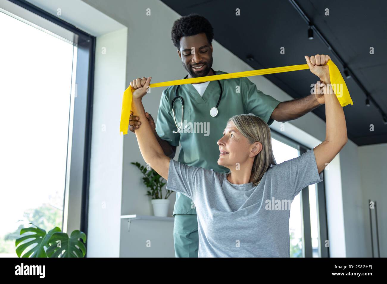 Lady working with chiropractor at rehabilitation center for treatment ...
