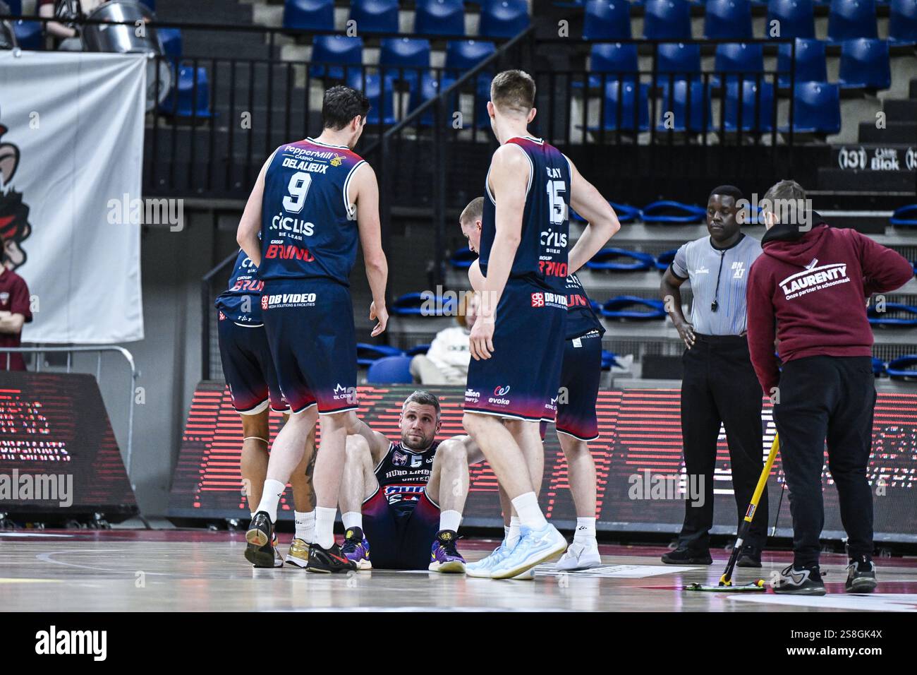 Limburg's Quentin Serron lies injured on the ground during a basketball ...