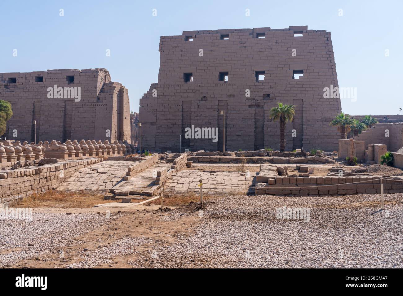 Ancient Egyptian Karnak temple with tall walls decorated with carvings ...