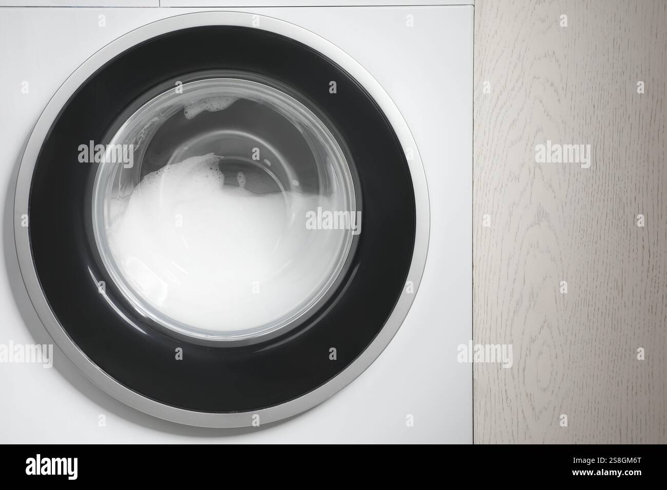 Washing machine with suds as background, closeup Stock Photo - Alamy