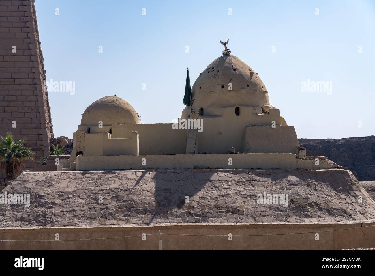 Ancient Egyptian Karnak temple with small mosque built inside the ruins ...