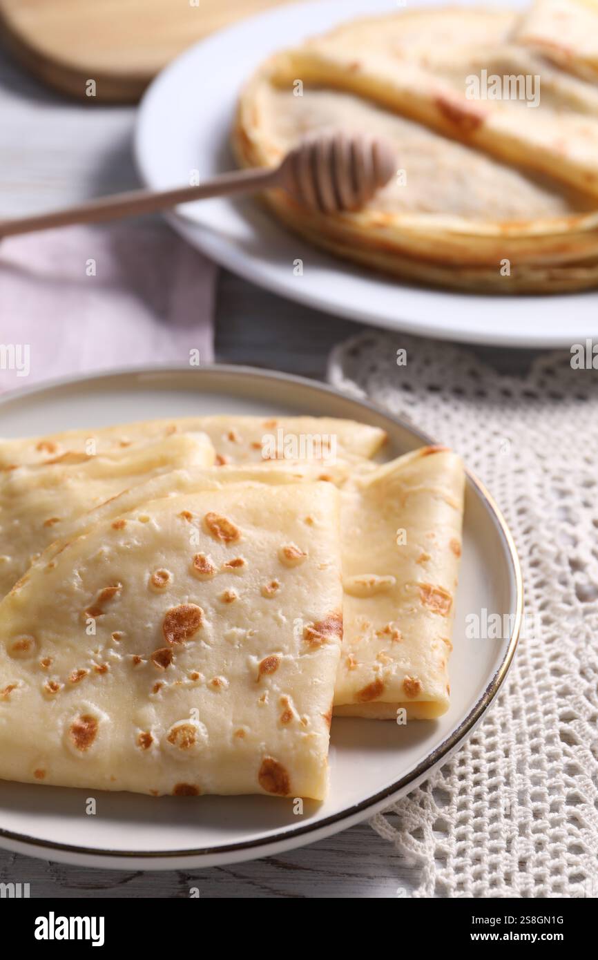 Delicious folded crepes on table, closeup view Stock Photo - Alamy