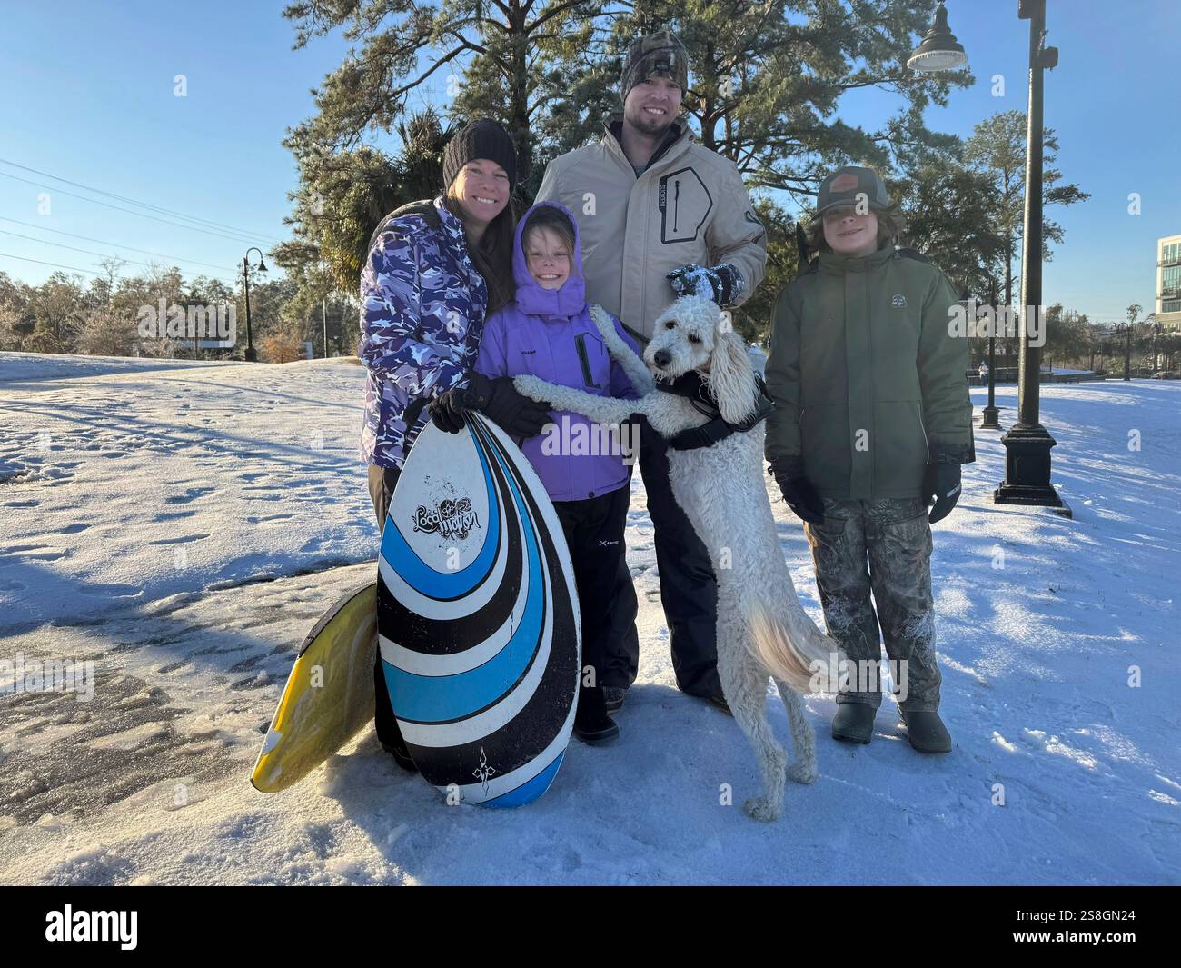 Alicia, from left, Layla, Michael and Rawley Holmes, and their golden ...