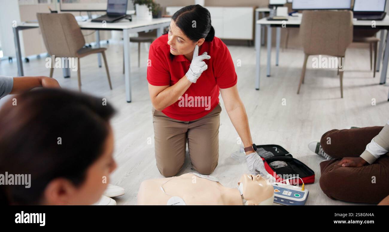 Mannequin, first aid and teaching with people and defibrillator for workshop, cardiac arrest or ...