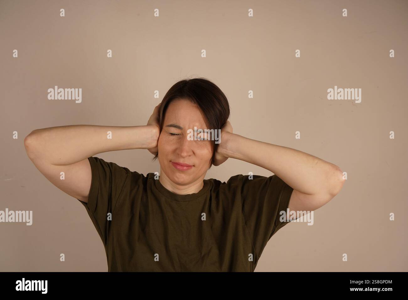 The person contorted his face from a severe headache. Near the gray ...