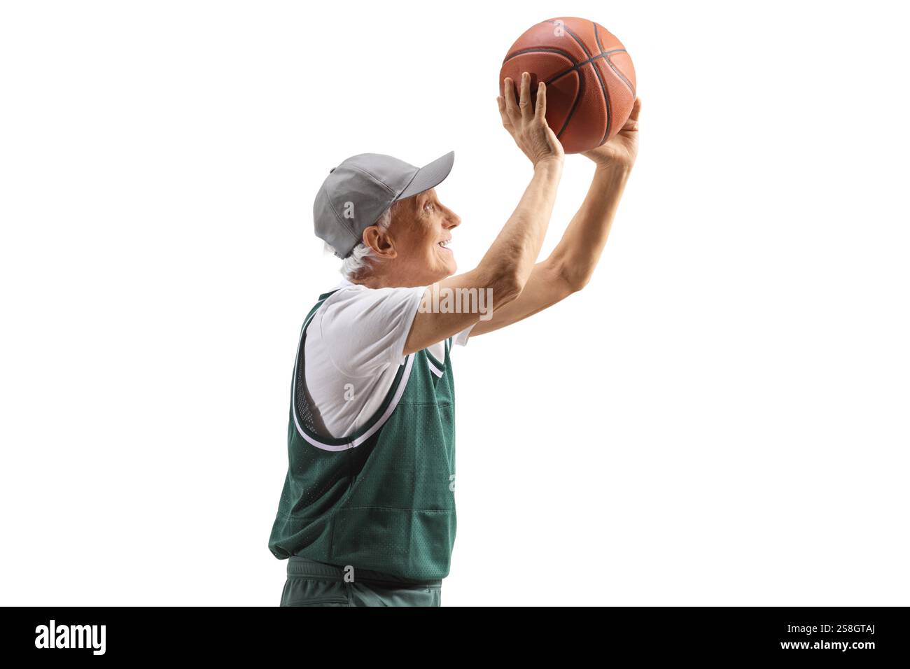 Elderly man shooting a basketball isolated on white background Stock ...
