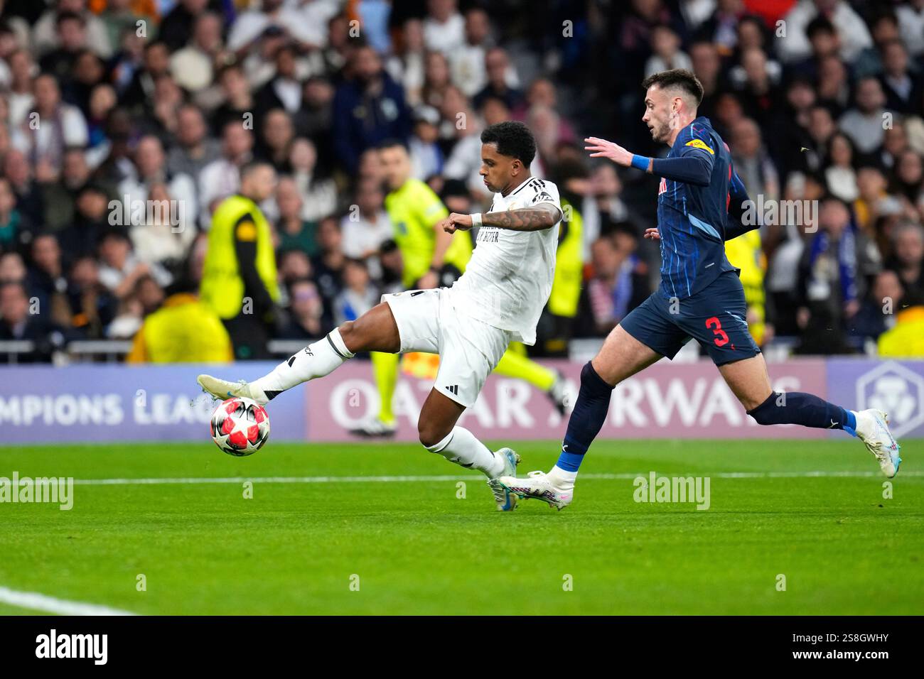 Real Madrid's Rodrygo, left, in action to score his side first goal ...