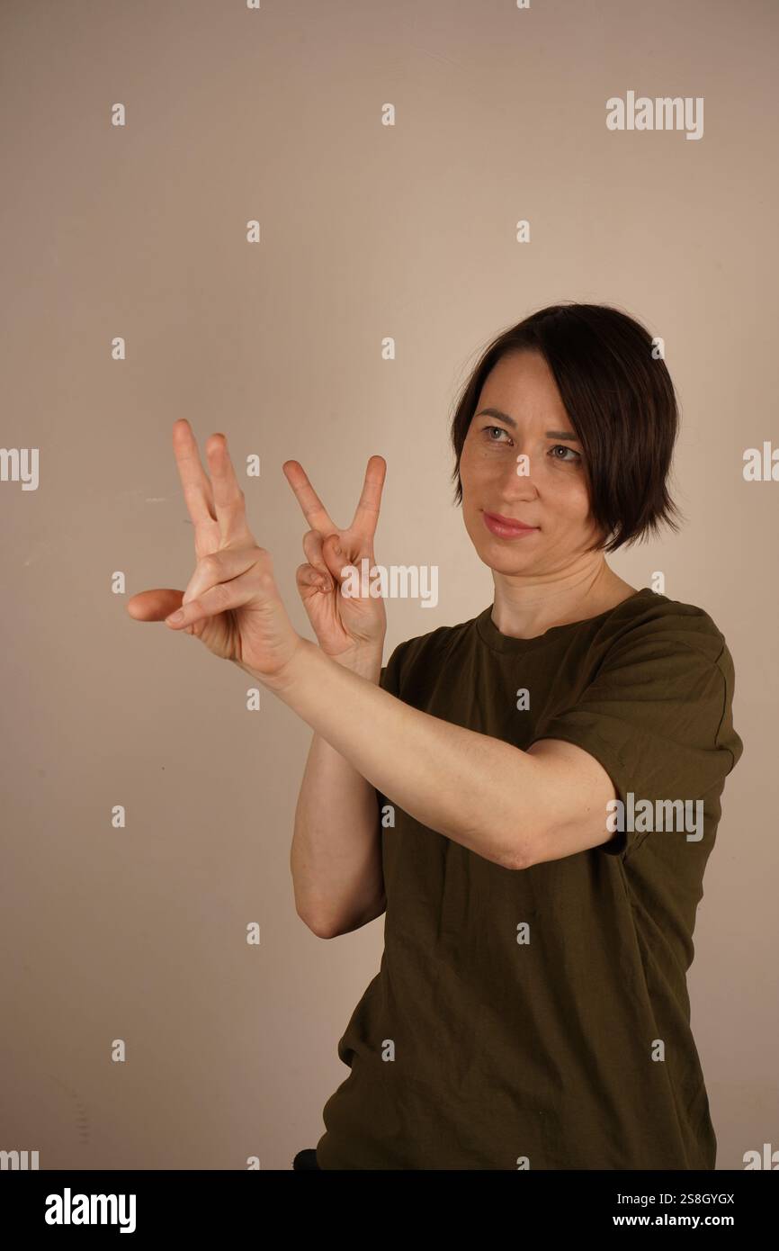 Asian young pretty happy female model in t-shirt and pants. Standing ...