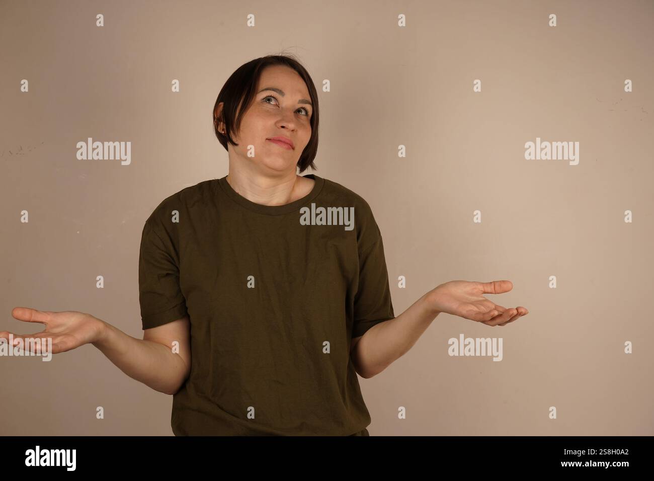 The concept of Shock and Surprise. A tense, confused girl spreads her ...